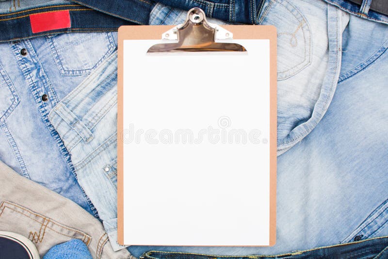 Jean Clothes and Folder on Wood Stock Photo - Image of casual, table ...