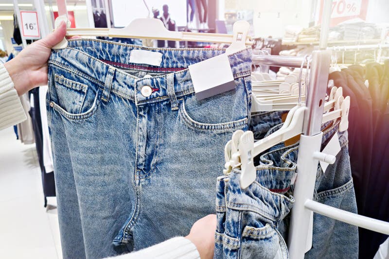 Jeans and a Customer in Clothing Store Stock Image - Image of clothes ...