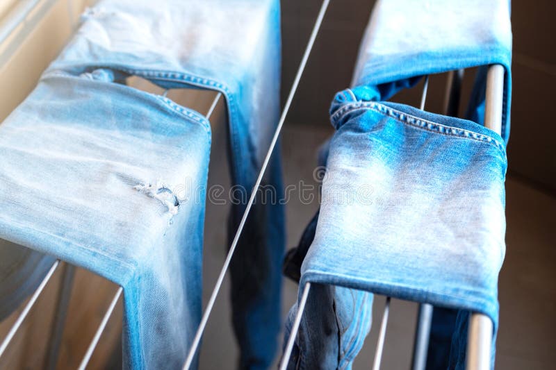Jeans Drying on the Dryer. Wet Blue Jeans Drying in the Apartment on ...