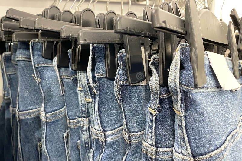 Jeans on Hangers in a Clothing Store, Close-up Stock Photo - Image of ...