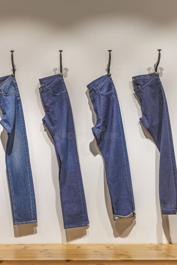 Jeans Models Hang on a White Wall in a Store. Style and Fashion Stock ...