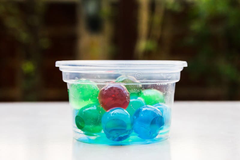 Jelly ball in plastic cup., Colorful jelly ball in plastic cup on white