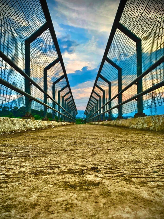 Symmetrical Perspective of a Metal Pedestrian Bridge with Concrete ...