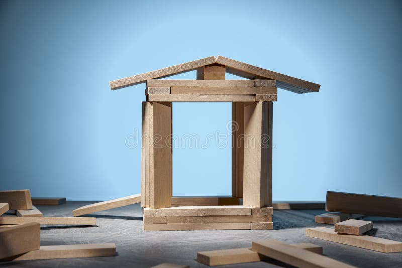 Jenga Game, A House Made Of Wooden Blocks On A Blue Background And ...