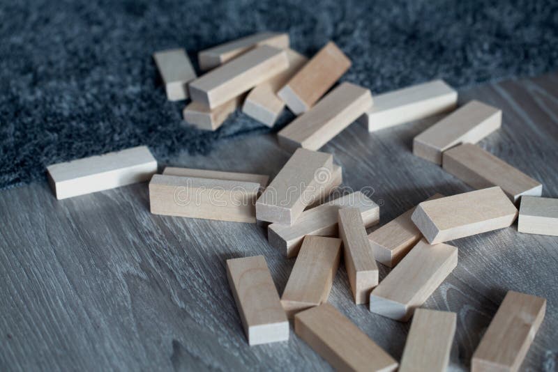 Jenga Game. Wooden Sticks of the Designer are Lying on the Gray Floor ...