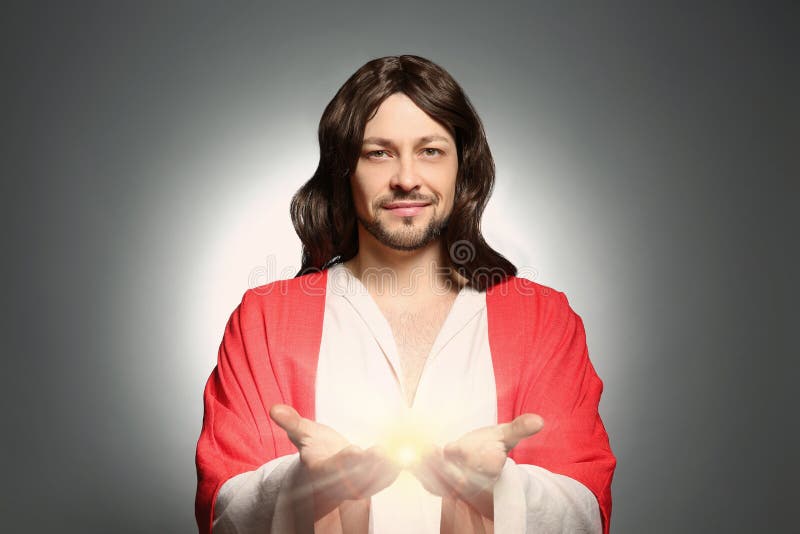 Jesus Christ on Grey Background. Miraculous Light in Hands Stock Photo ...