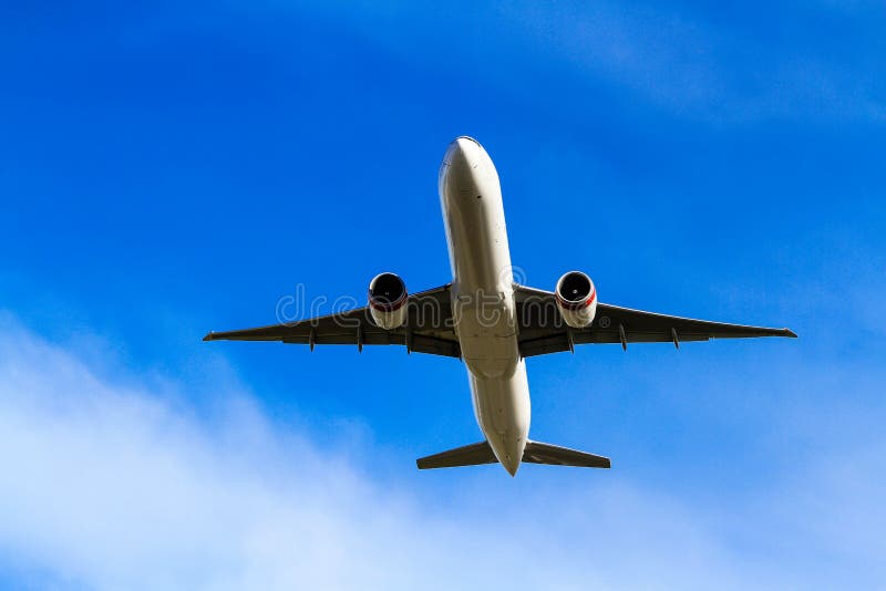 Jet Airliner Flying Under Blue Sky Stock Photo - Image of travel, heavy ...