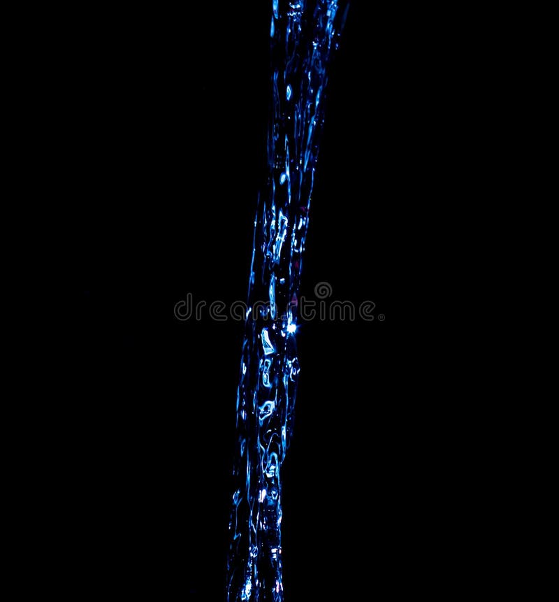A Jet of Blue Water is Isolated on a Black Stock Image - Image of ...