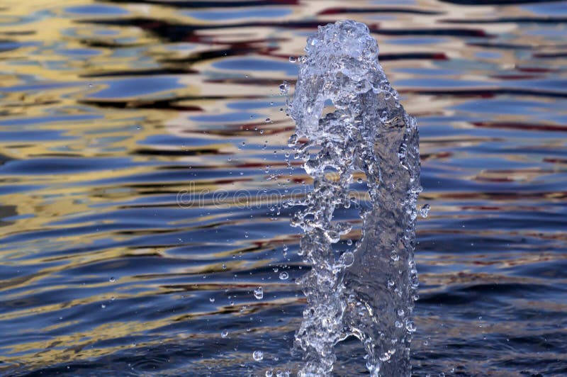A Jet of Clear Blue Water in the Fountain and Drops of Water in Flight ...