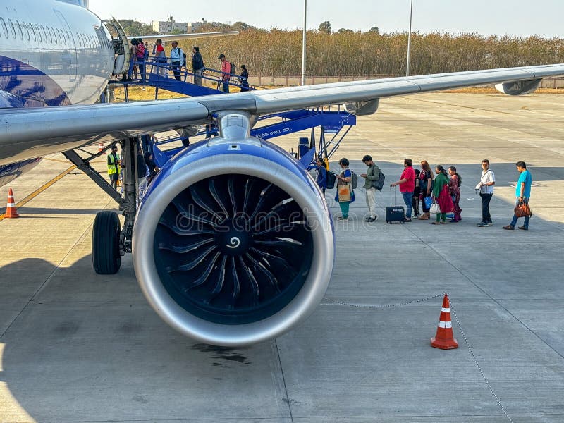 A Jet Engine is on the Ground with People Walking Around it Editorial ...