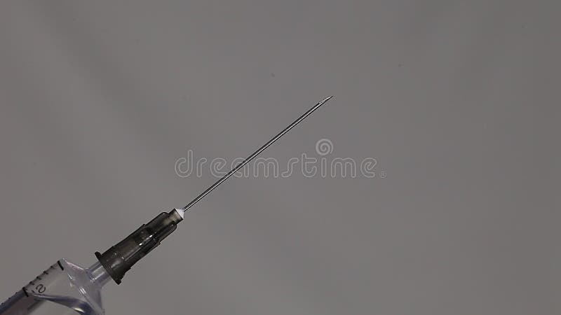 Jet of Liquid Escapes from the Syringe Needle Under Pressure. Macro ...
