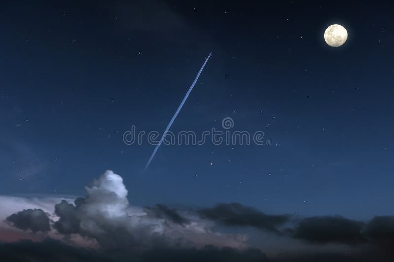 Jet Plane with Contrail Flying through Clouds in the Night Sky with ...