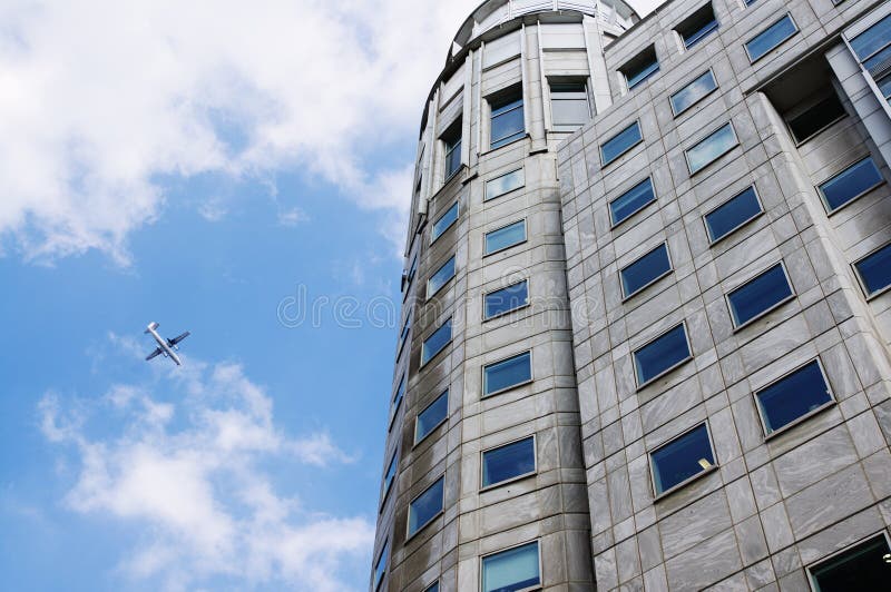 Jet Plane Flying Low Over Commercial Office Building Stock Image ...