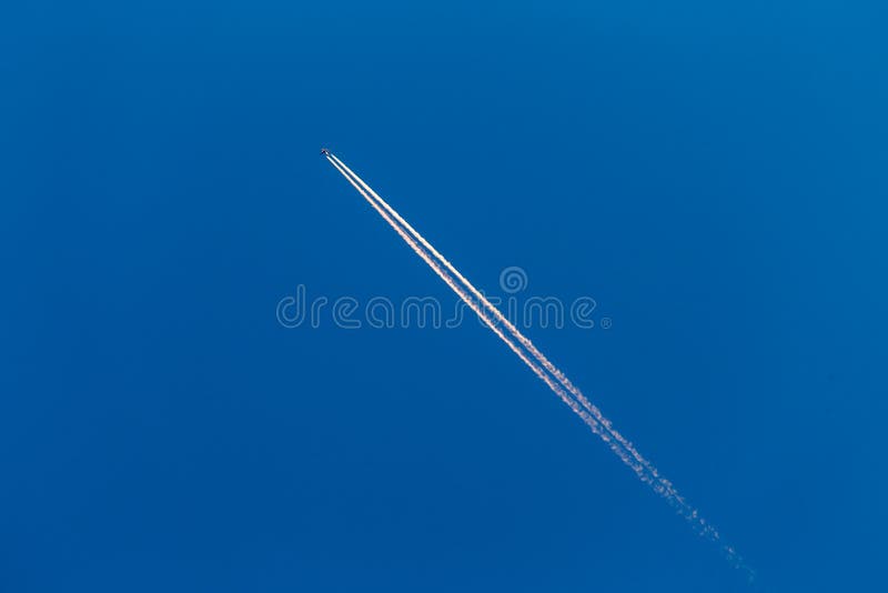 Jet Plane Leaves Double Contrail in a Shine Clear Blue Sky Flying on ...