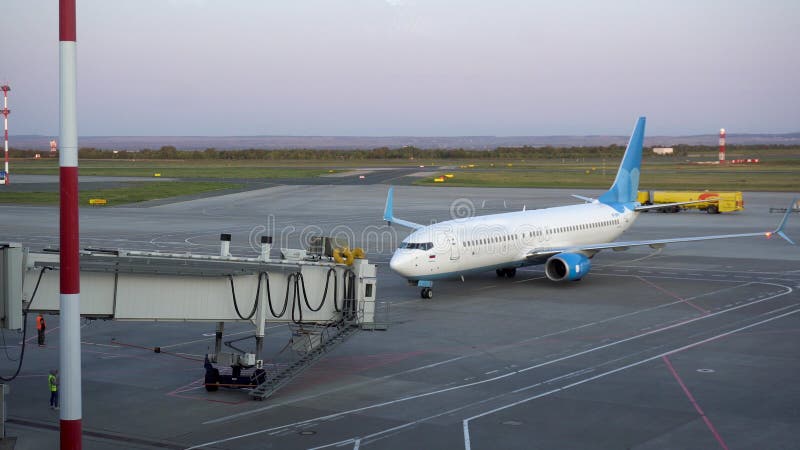 Jet Plane Pulls Up To the Gate. Boeing 737 on the Aircraft Platform ...