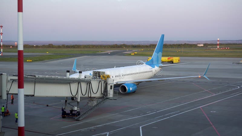 Jet Plane Pulls Up To the Gate. Boeing 737 on the Aircraft Platform ...