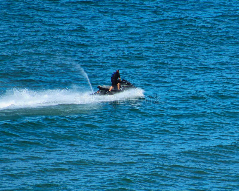 Jet Ski Playing on a Sharp Blue Colo Sea Editorial Stock Photo - Image ...