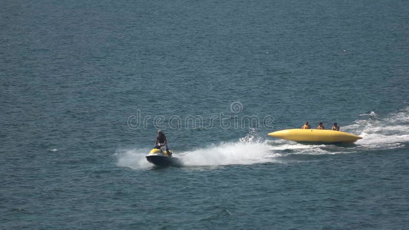 Jet Ski Pulling Inflatable Raft with a Man Stock Footage - Video of ...