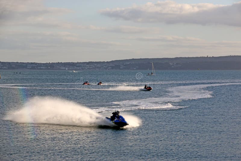 Jet skis in Torbay, Devon stock image. Image of clouds - 248388879