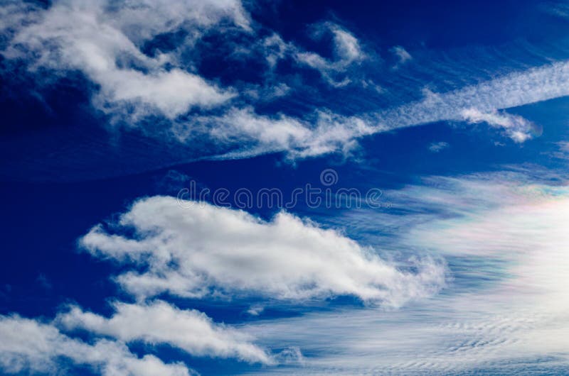 Jet Trail through a Cloud Pattern in the Blue Sky Stock Image - Image ...