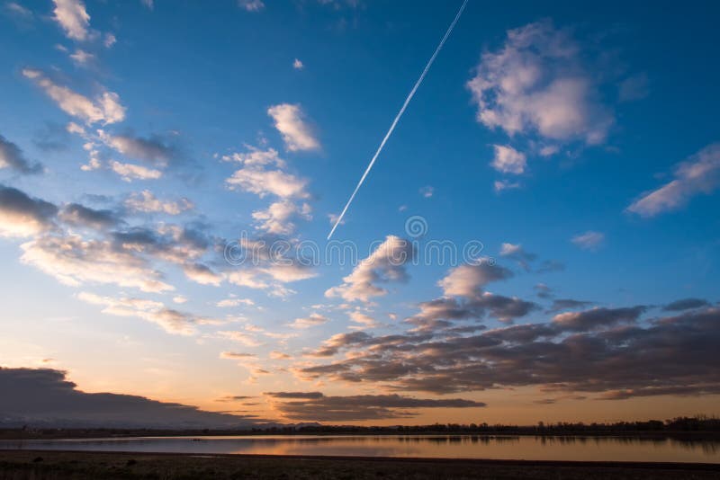 Jet Trail at Sunset stock image. Image of reservoir, reflection - 85218695