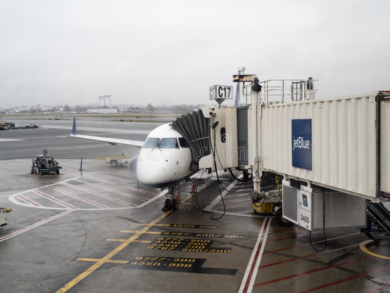 A Jetblue Plane Waits at the Terminal Attached To the Jetway Editorial ...