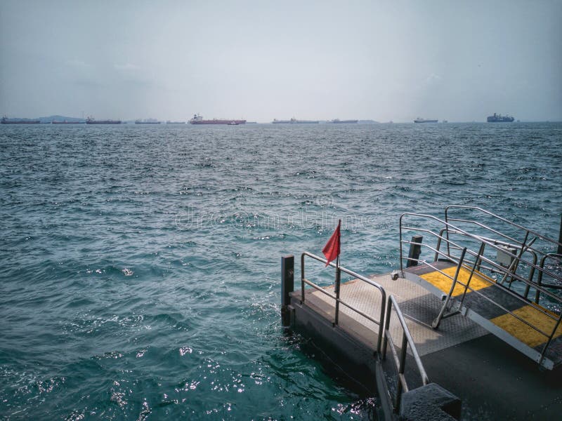 Jetty Dock by the Sea with Red Flag Stock Image - Image of jetty, flag ...