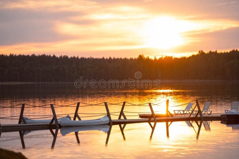 Jetty with Kayaks on the Lake during Sunset Stock Image - Image of ...