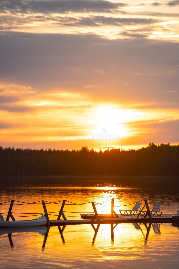 Jetty with Kayaks on the Lake during Sunset Stock Image - Image of ...