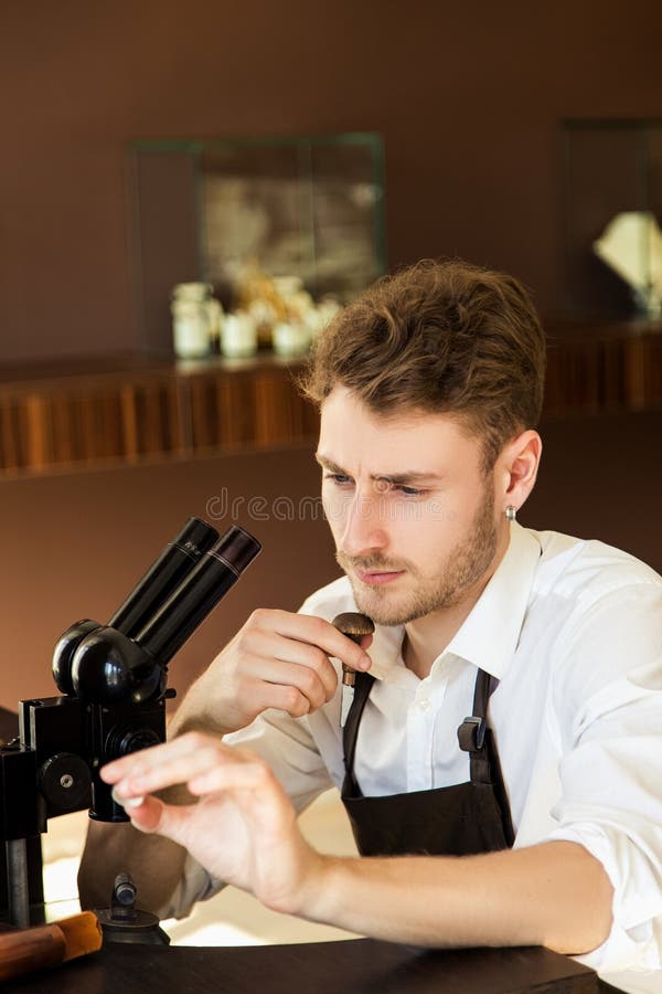The Jeweler Holds in His Hands and Looks at the Ring Stock Photo ...