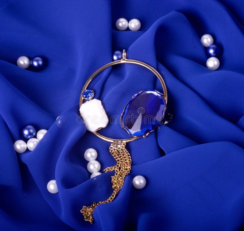 Jewelry on blue background stock image. Image of feminine - 23745367