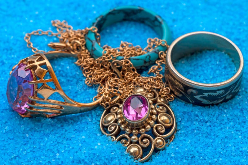 Jewelry in blue sand stock photo. Image of blue, closeup - 88778062