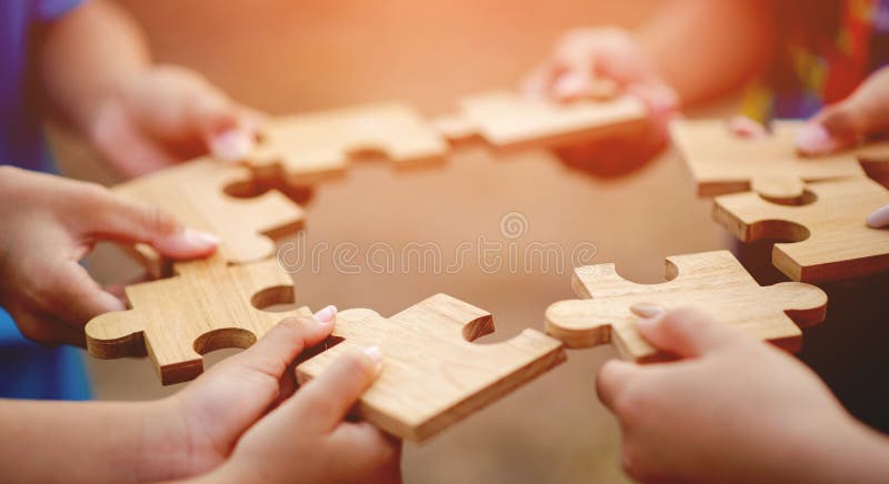 Jigsaw in Hand Puzzle Pieces Gather Together Teamwork the Concept of ...