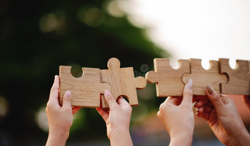 Jigsaw in Hand Puzzle Pieces Gather Together Teamwork the Concept of ...