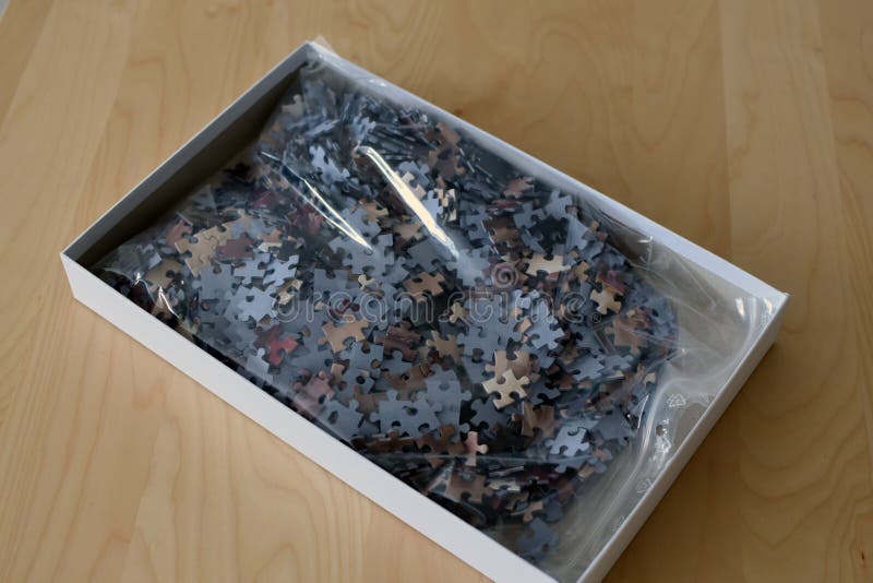Jigsaw Pieces in a Plastic Bag in a Puzzle Box Stock Image - Image of ...