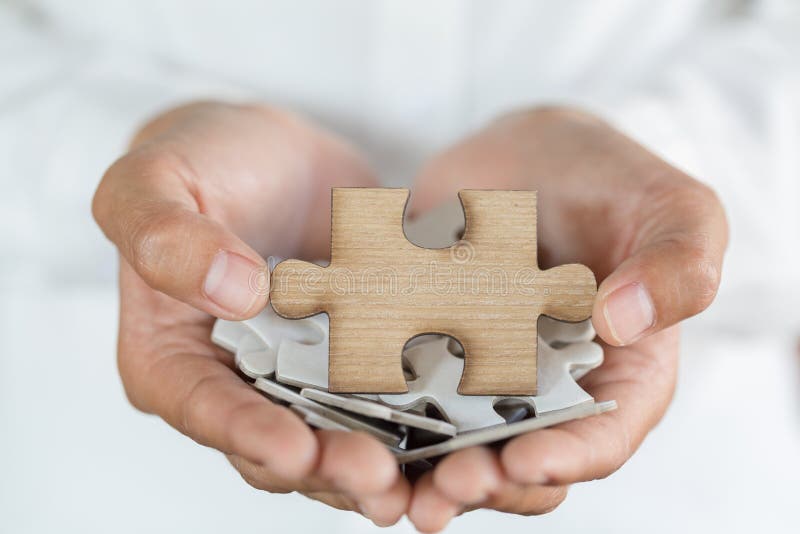Jigsaw Puzzle in the Hand of a Businessman, Business Team Assembling ...