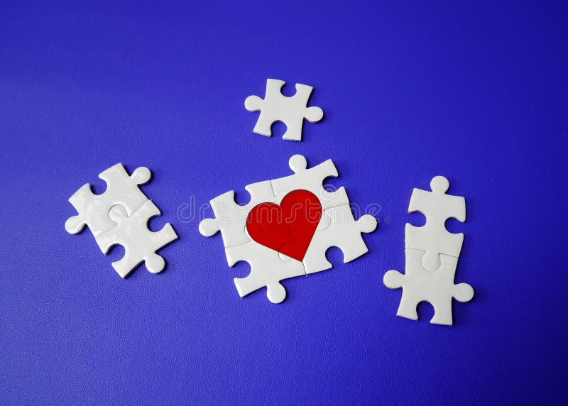 Jigsaw Puzzle Pieces in Form of Heart on a Blue Background. Stock Image ...