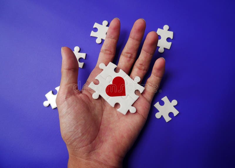 Jigsaw Puzzle Pieces in Form of Heart on a Blue Background. Stock Image ...