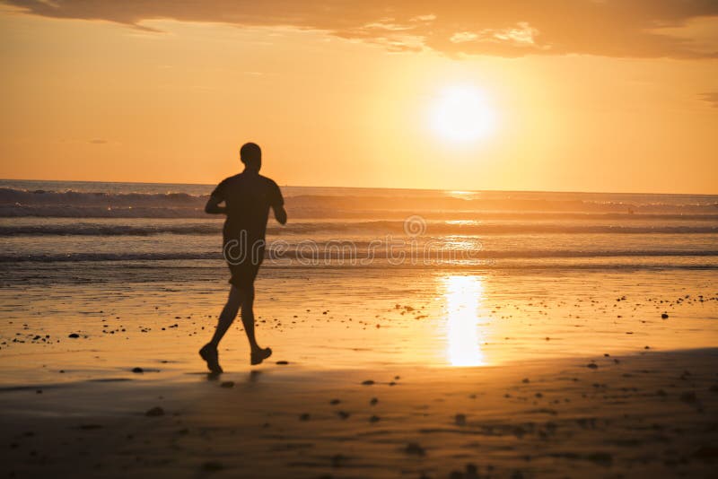 Jogger on a Beach at Sunset Silouhaite Stock Photo - Image of walk ...