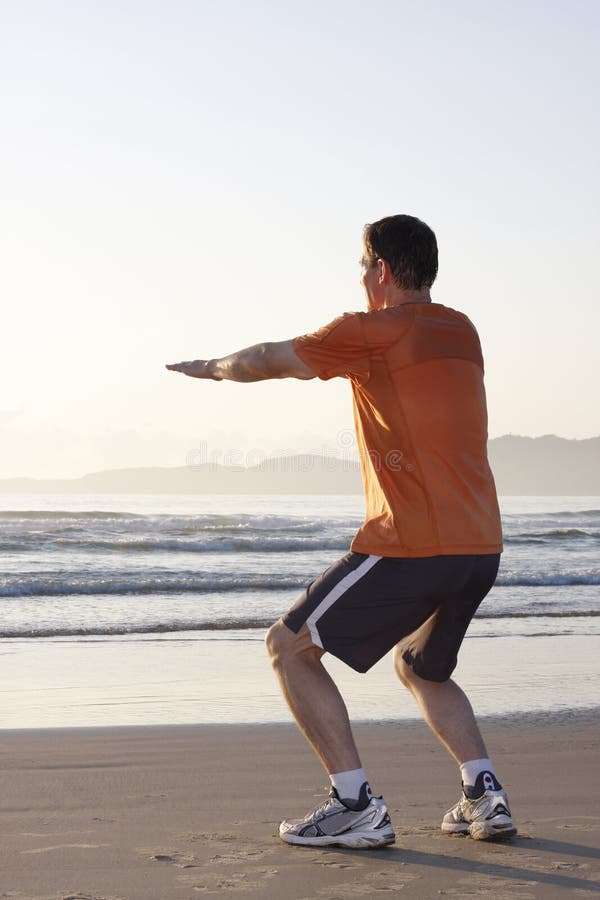Jogger doing squats stock photo. Image of ocean, people - 12876456