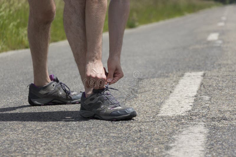 Jogger Man Binding the Shoe Strings Stock Photo - Image of feet ...