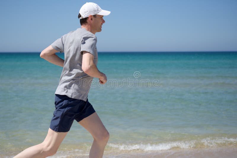 Jogging on a beach stock image. Image of recreational - 40962095