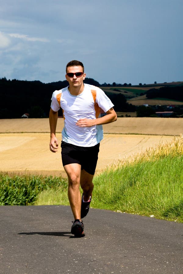 Jogging through the fields stock photo. Image of male - 11243438