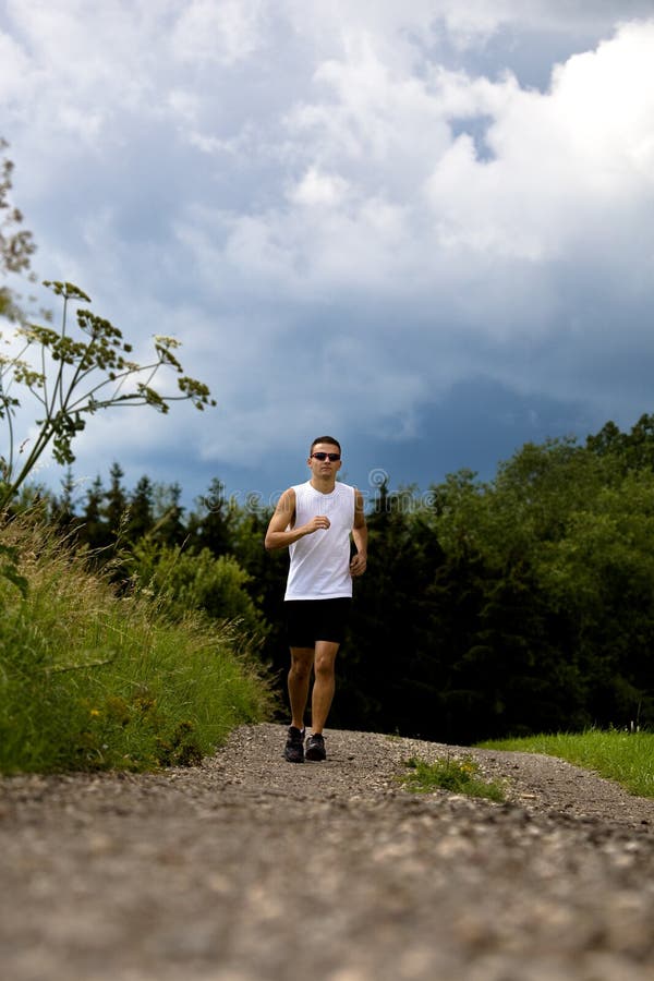 Jogging through the fields stock photo. Image of adult - 11257320