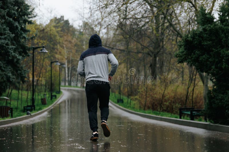 Jogging in the Rain a Physical Challenge for Young Adults Stock Photo ...