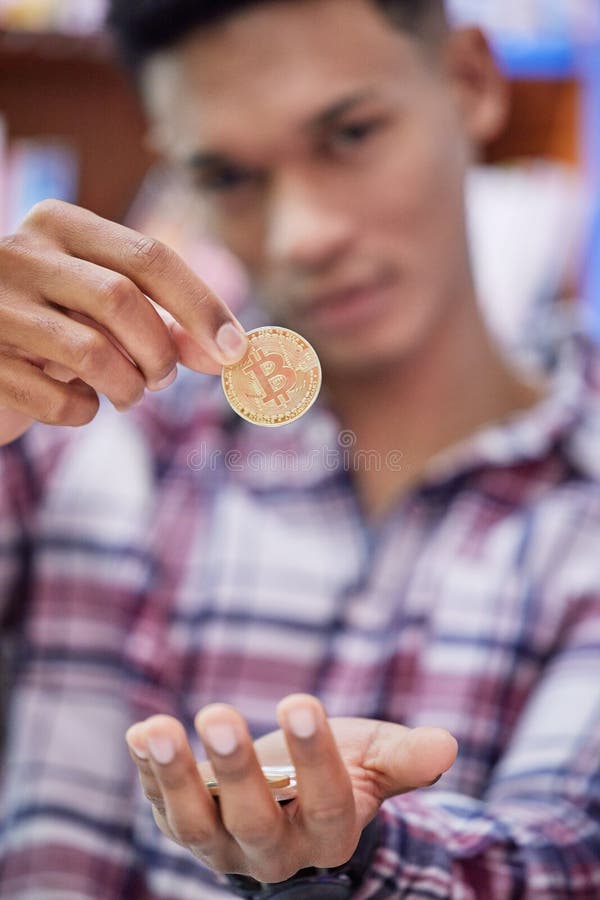 Join My Peer To Peer Network. Shot of a Young Man Holding Bitcoins ...