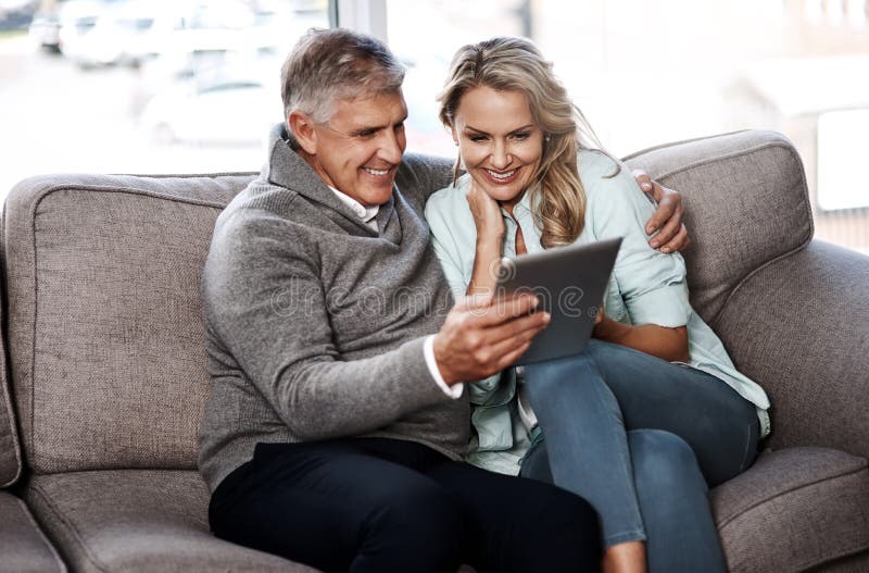 Joining in on a Connected World. a Mature Couple Using a Digital Tablet ...