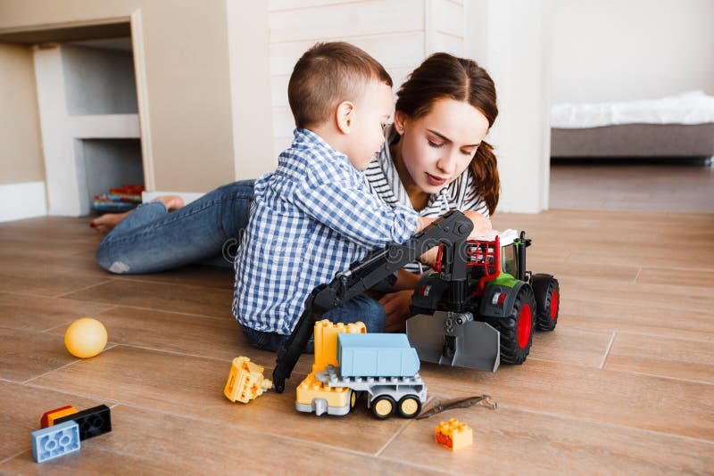 Mom and Son Playing with Plastic Tractor Stock Photo - Image of ...