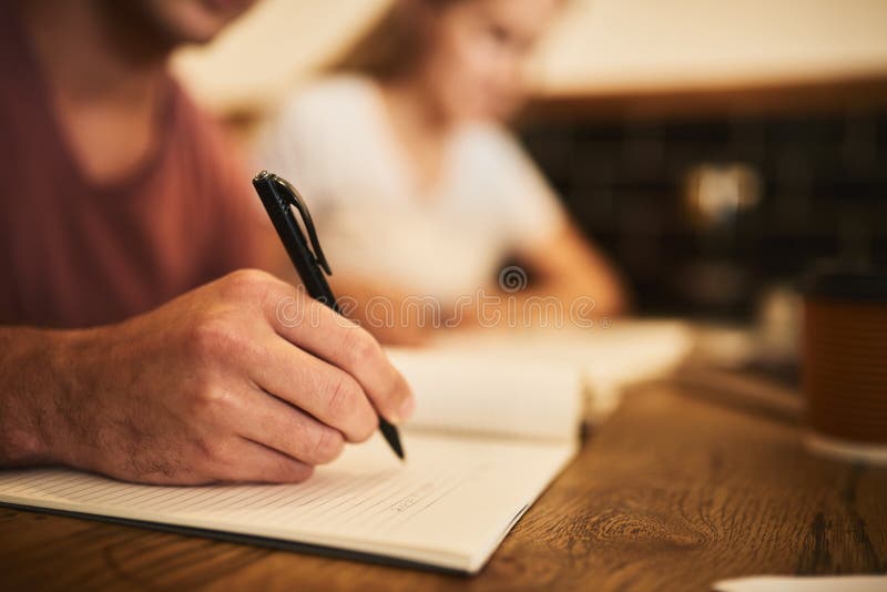 Jotting Down Every Important Detail. Two Unidentifiable Students Having ...