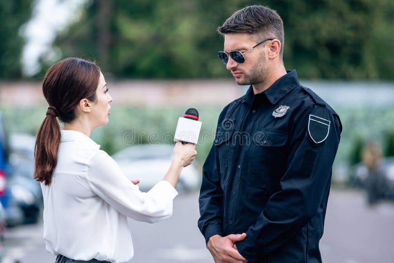 Journalist Holding Microphone and Talking with Handsome Policeman Stock ...
